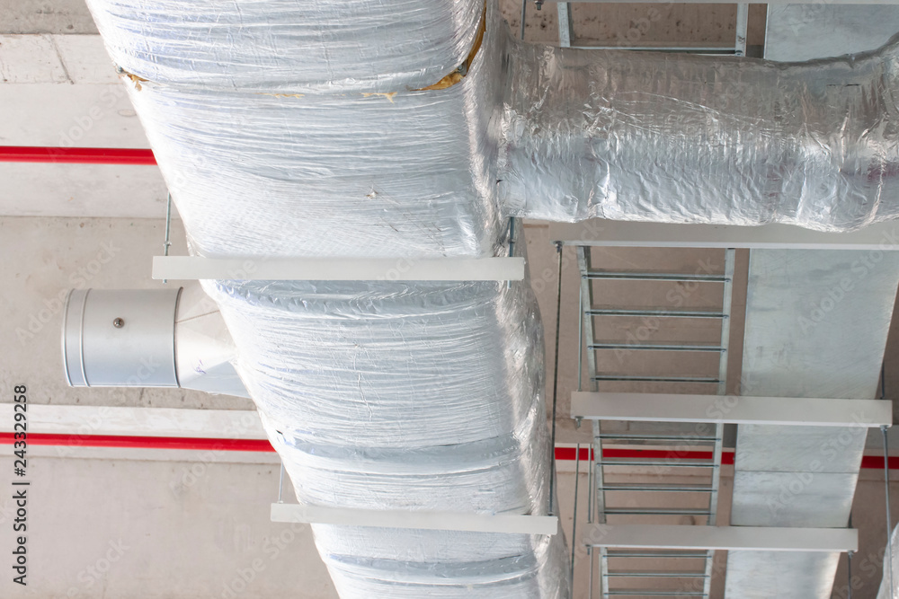 Typical installation of ducting with fiberglass insulation work combine ...