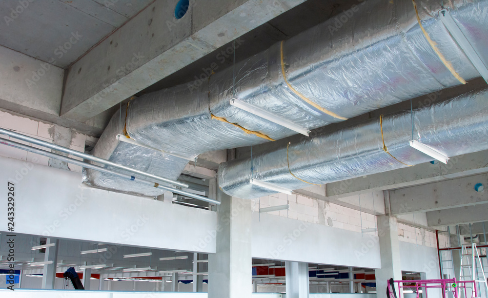 Typical installation of ducting with fiberglass insulation work combine ...