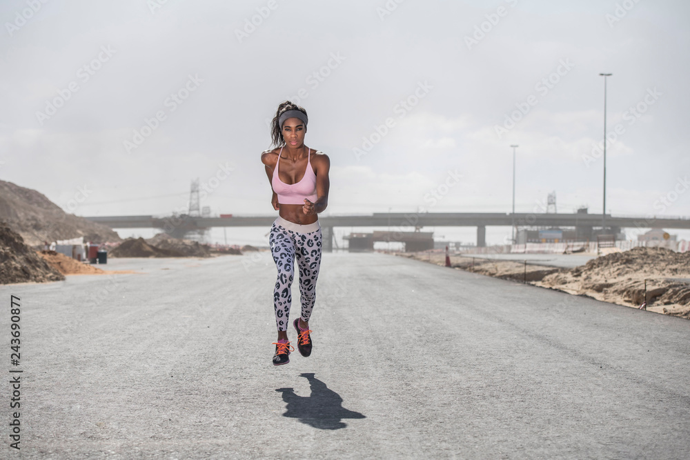 Strong athletic African American Black woman wearing long black and ...