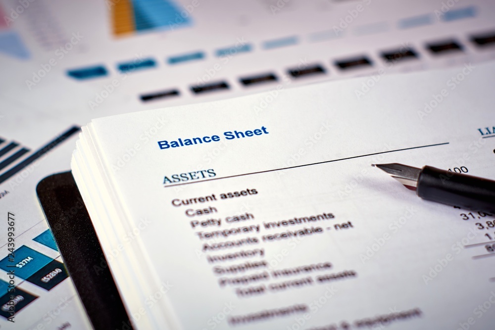 balance sheet and pen on the background of financial documents, close ...