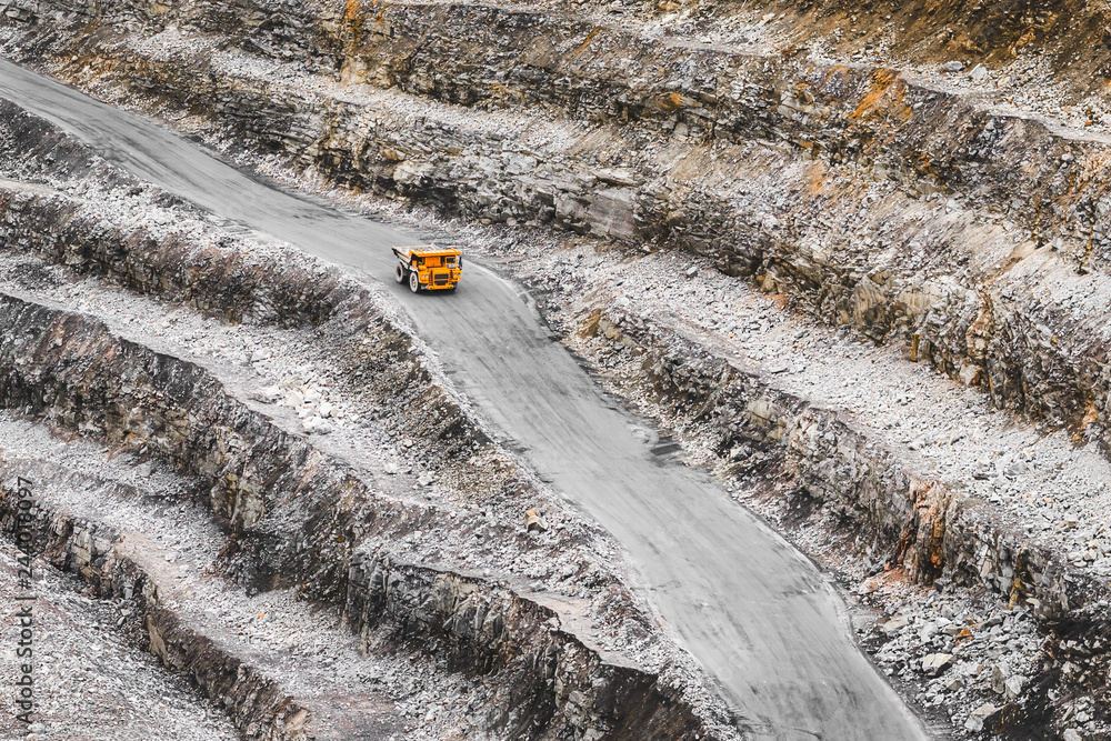 Large orange mining truck in a quarry. Iron ore extraction. Heavy ...