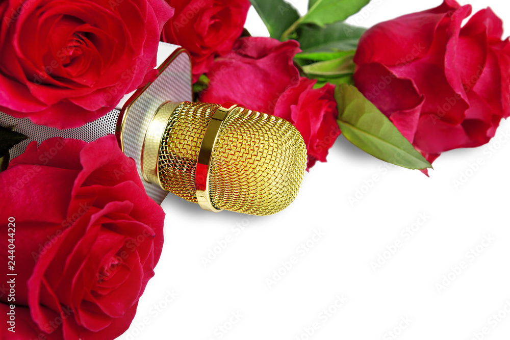Golden microphone with a bouquet of red roses lie on a white background ...