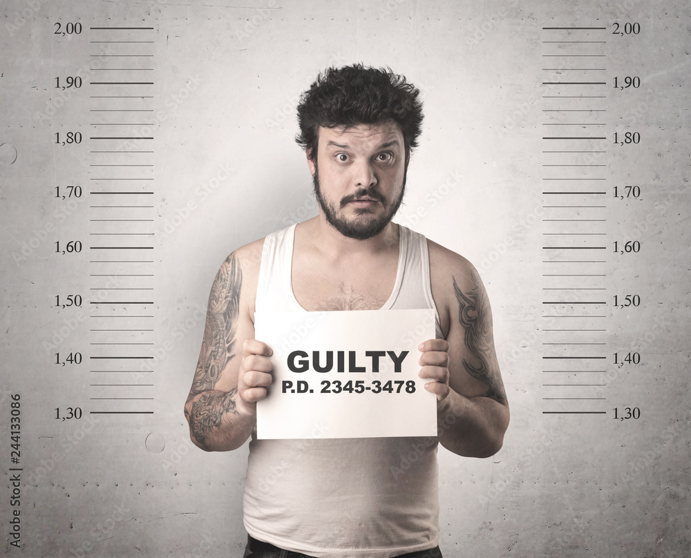 Caught guilty man with ID signs on his hand. Stock Photo | Adobe Stock