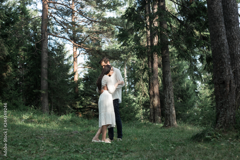 Young beautiful Slavic couple in love walks through the woods, sweet ...