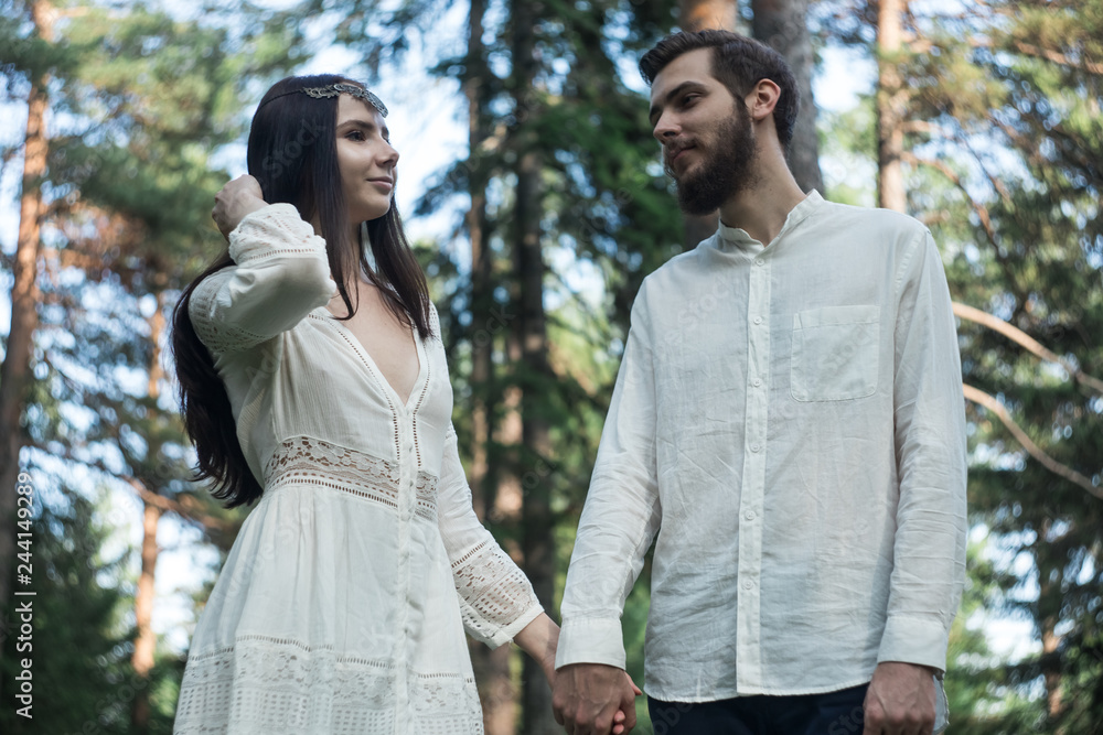 Young beautiful Slavic couple in love walks through the woods, sweet ...