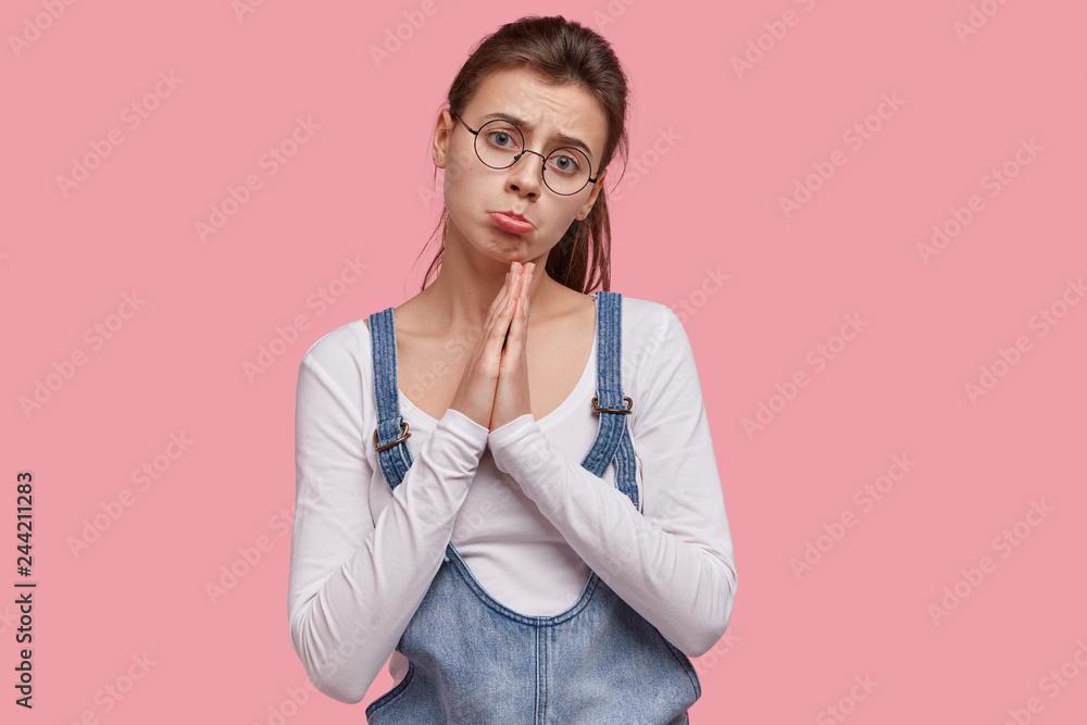 Sad young woman about to cry, asks desperate for help, holds hands in ...