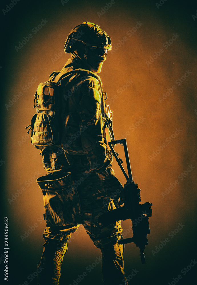 Low key studio shoot of army special forces soldier, commando fighter ...