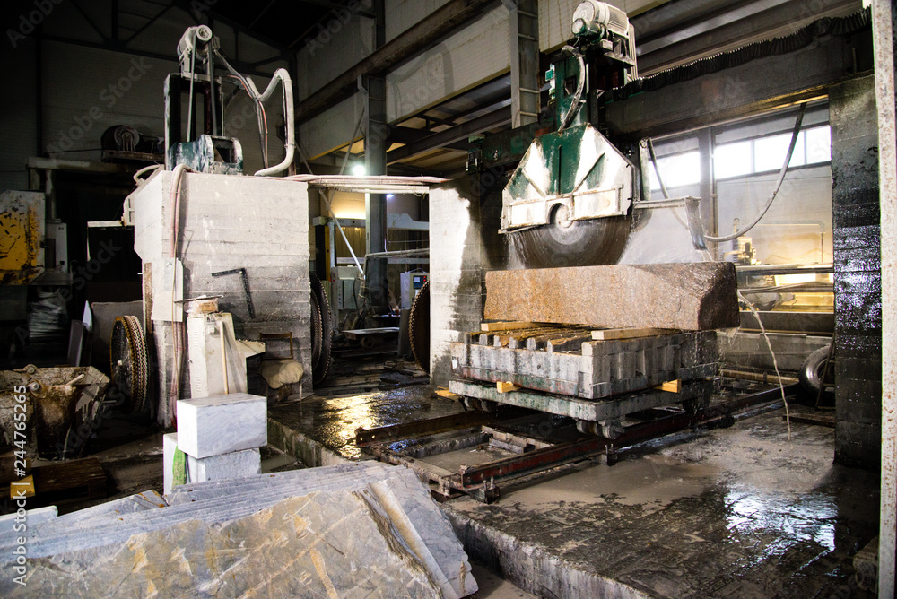 Granite processing in manufacturing. Cutting granite slab with a ...