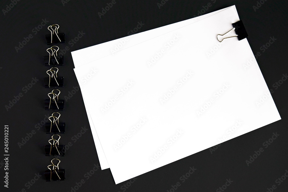White sheets and binder clip device for tying paper sheets together on ...