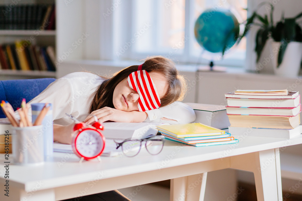 Female student preparing for exams late night at library sleeping on ...