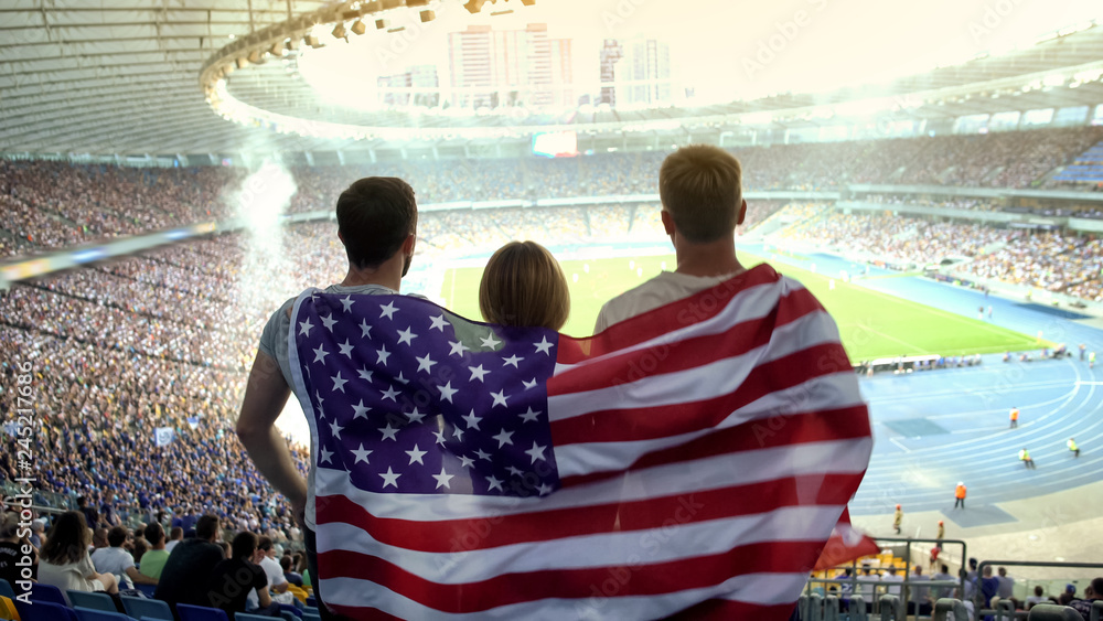 Football fans with American flag jumping at stadium, cheering for ...