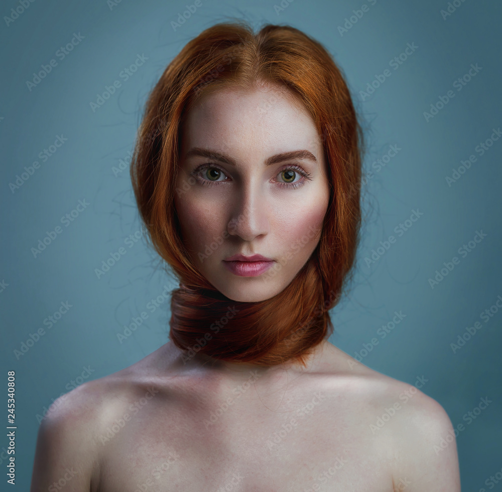 Close up portrait of a gorgeous red headed woman with naked shoulders ...