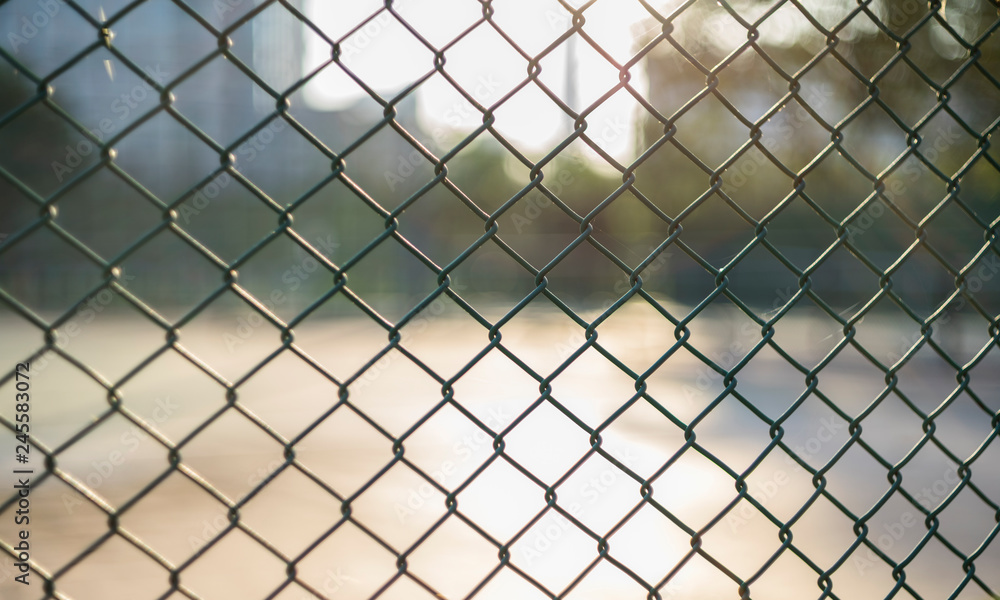 Close-up chain link fence , Sunset background Stock Photo | Adobe Stock