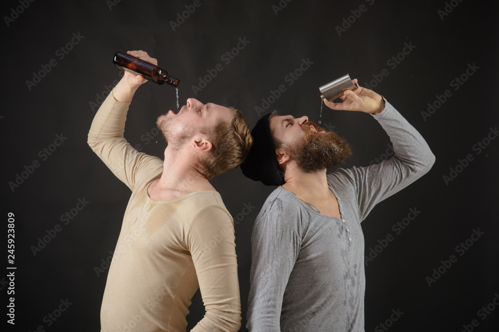 Used to drink alcohol. Hard drinkers. Men drinking alcohol from bottle ...