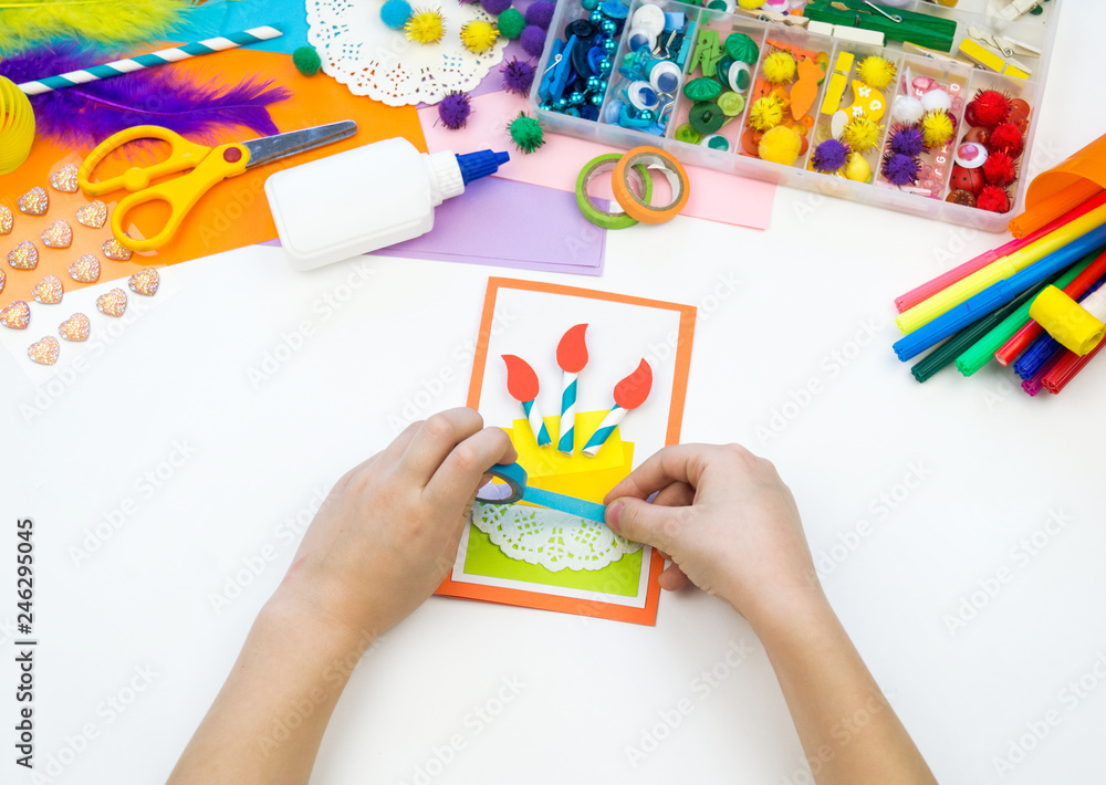 Child makes a postcard with a picture of a cake. Kid paperwork. Stock ...