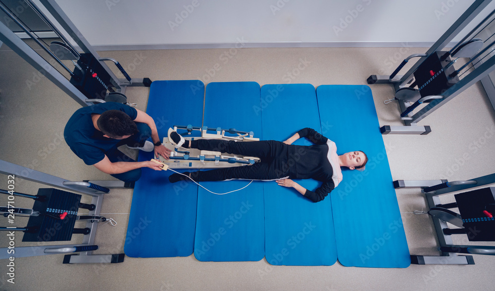 Patient on CPM (continuous passive range of motion) machines. Device to ...