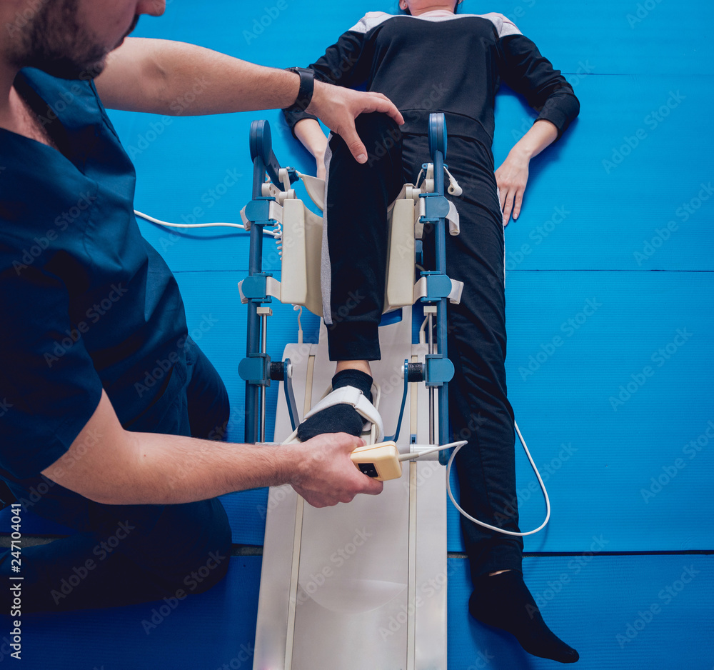 Patient on CPM (continuous passive range of motion) machines. Device to ...