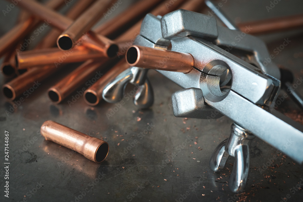 Pipe rammer tool on a fitter workbench. Pipework concept background ...