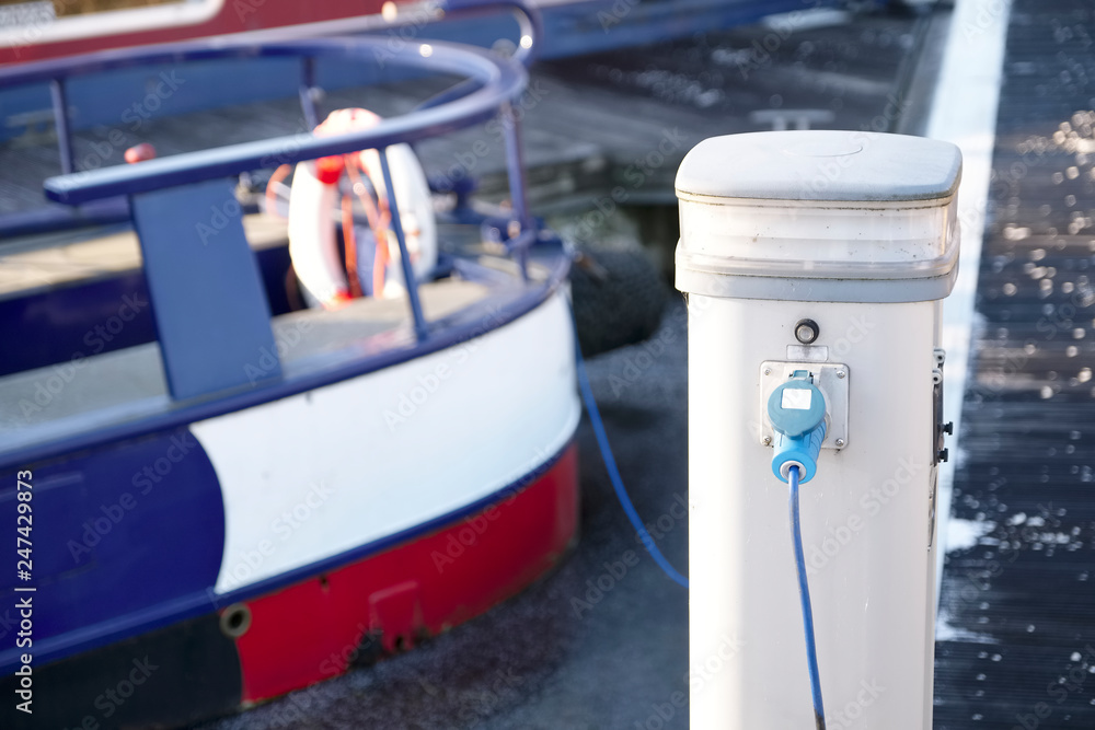 Electric charging point for boat and barge at marina mooring on canal ...