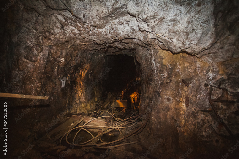 Inside old closed coal mine; dangerous tunnels full of dirt, lots of ...