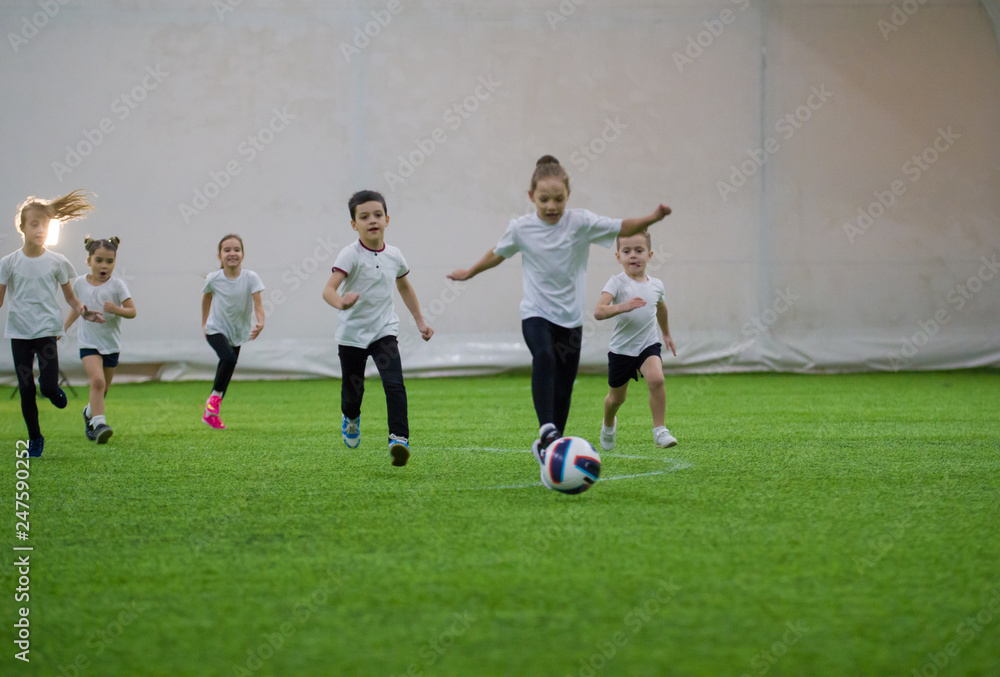 Little kids playing football indoors. Children football team playing on ...