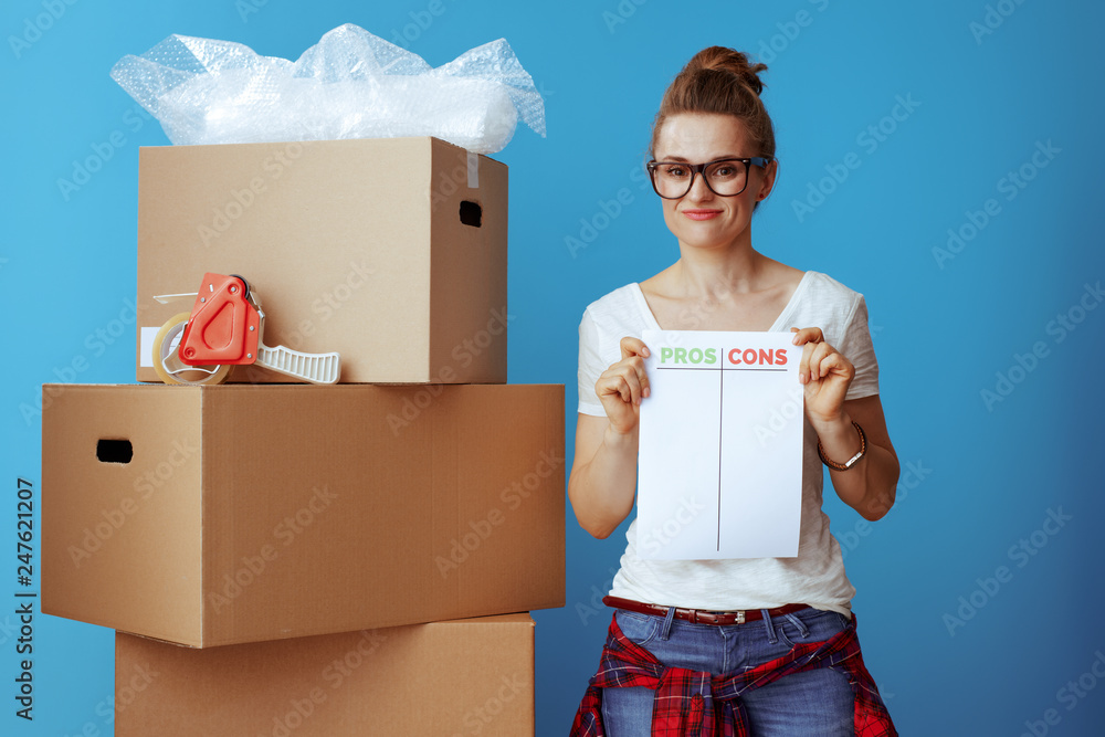 doubting woman near cardboard box with pros cons list on blue Stock ...