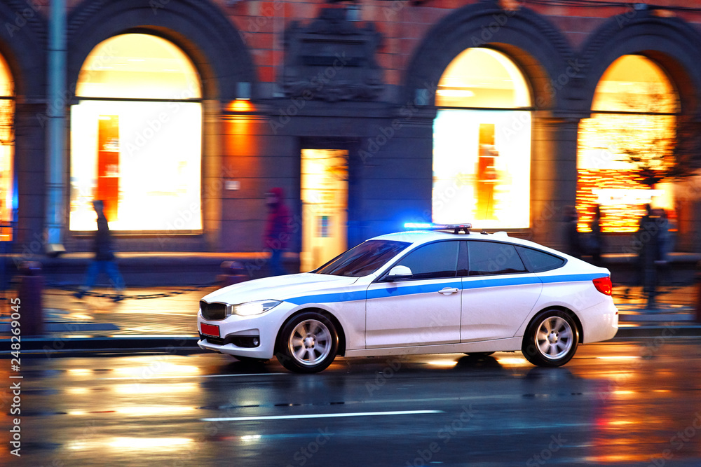 Photo Stock Police car speeding down the street to emergency with the ...