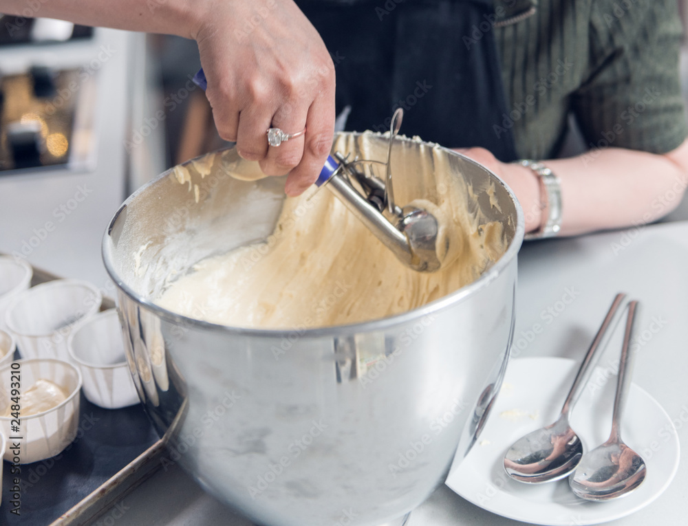 a knob of butter and sugar icing mix in a metal mixing bowl ready to be ...
