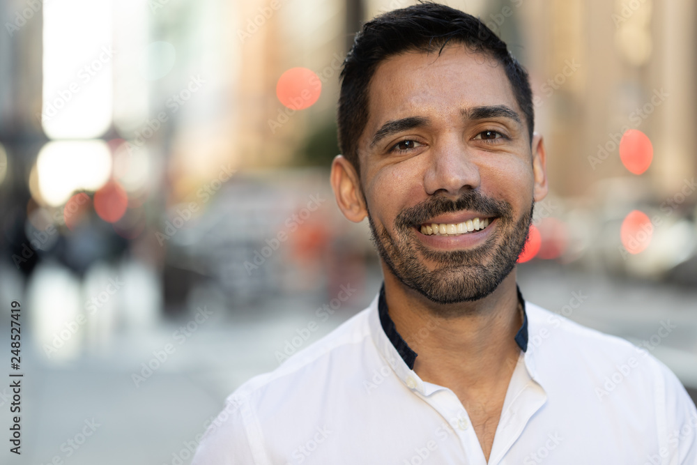 Young Latino Hispanic man in city smile happy face Stock Photo | Adobe ...