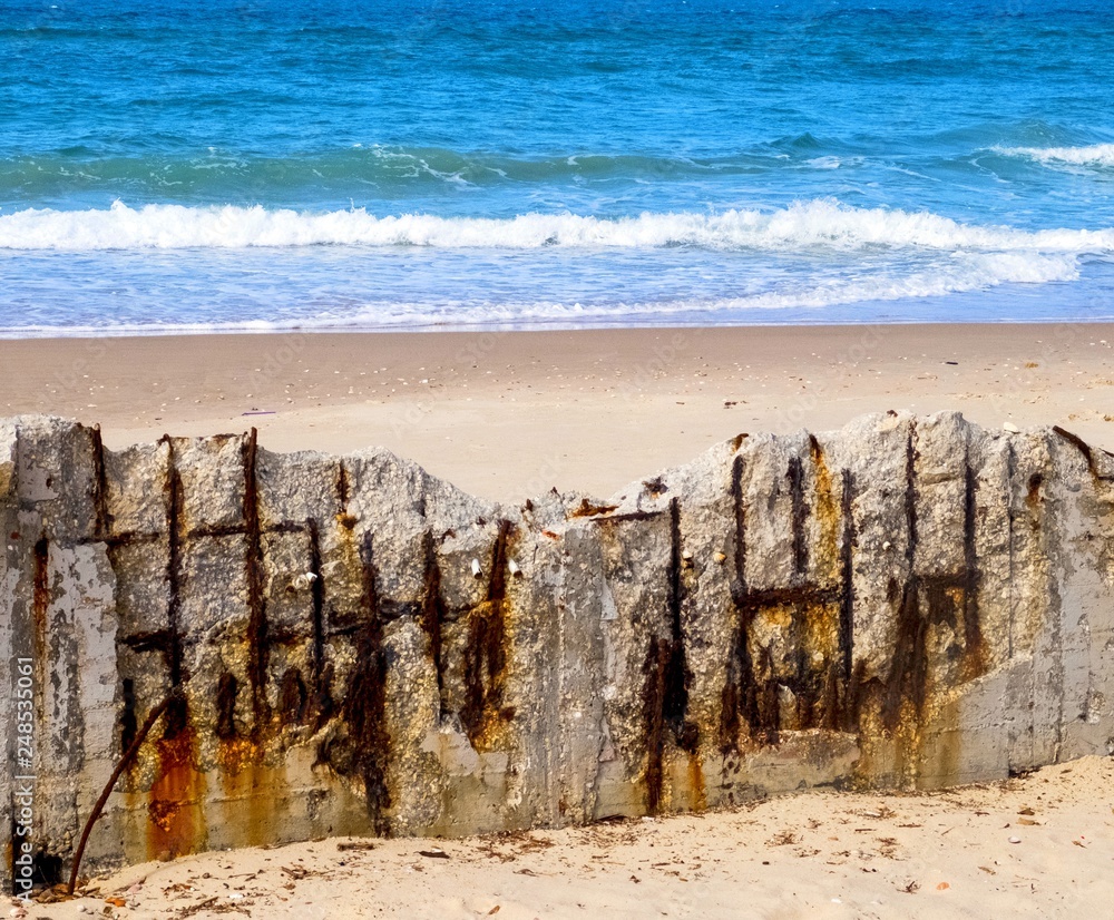 Reinforced concrete structure on the beach, collapsing from moisture ...