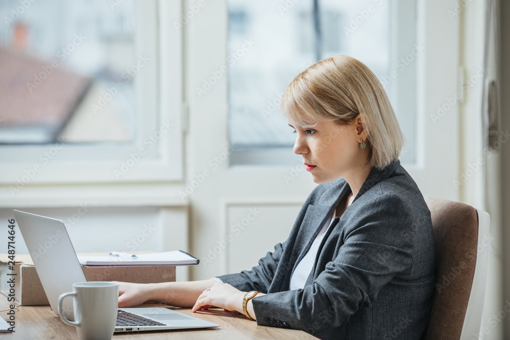 Young woman reading an email from the laptop Stock Photo | Adobe Stock