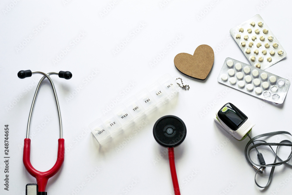 Medical flatlay composition on white background. Treating heart ...