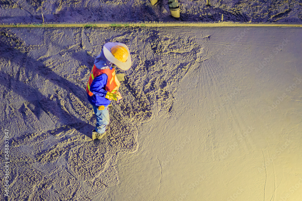 Mason worker leveling concrete with trowels, mason hands spreading ...