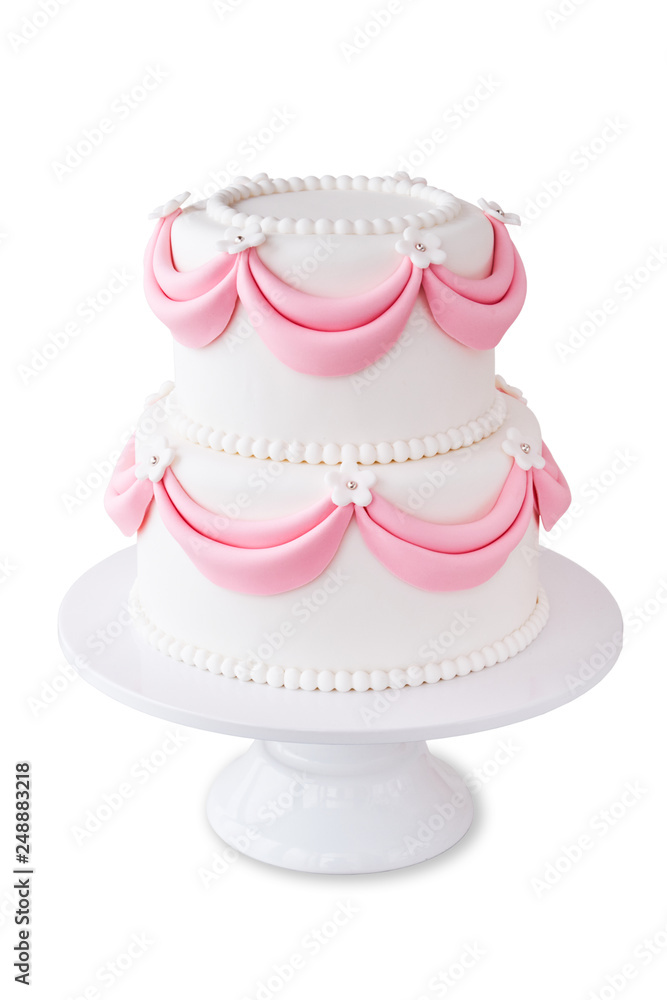 White wedding cake with pink elements made from pastry mastic isolated ...