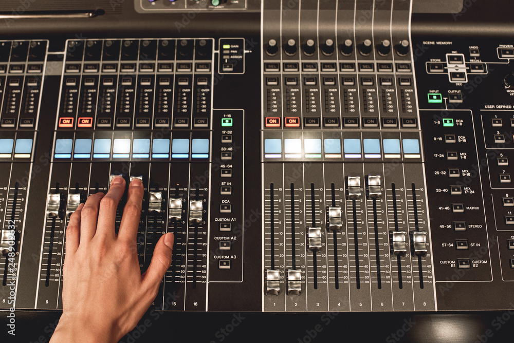 Professional sound control. Close-up view of male hand mixing sounds on ...