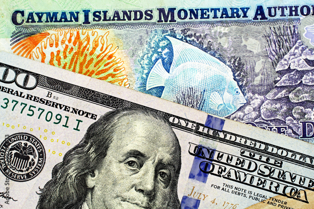 An ocean themed Cayman Islands dollar bill with a blue American one ...