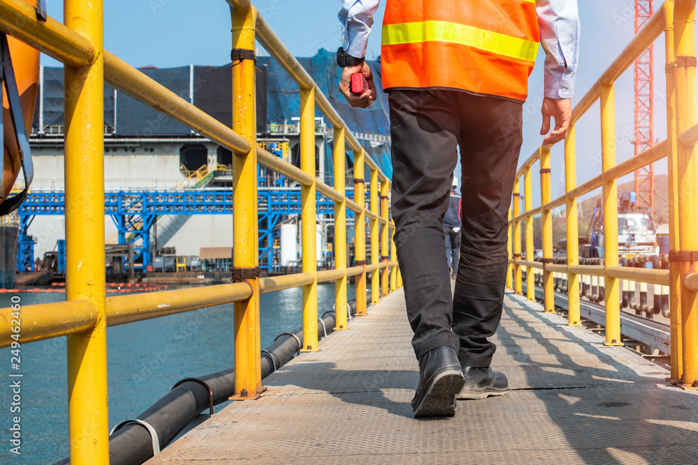 Safety shoe of worker walking in mind step on the steel checker plate ...