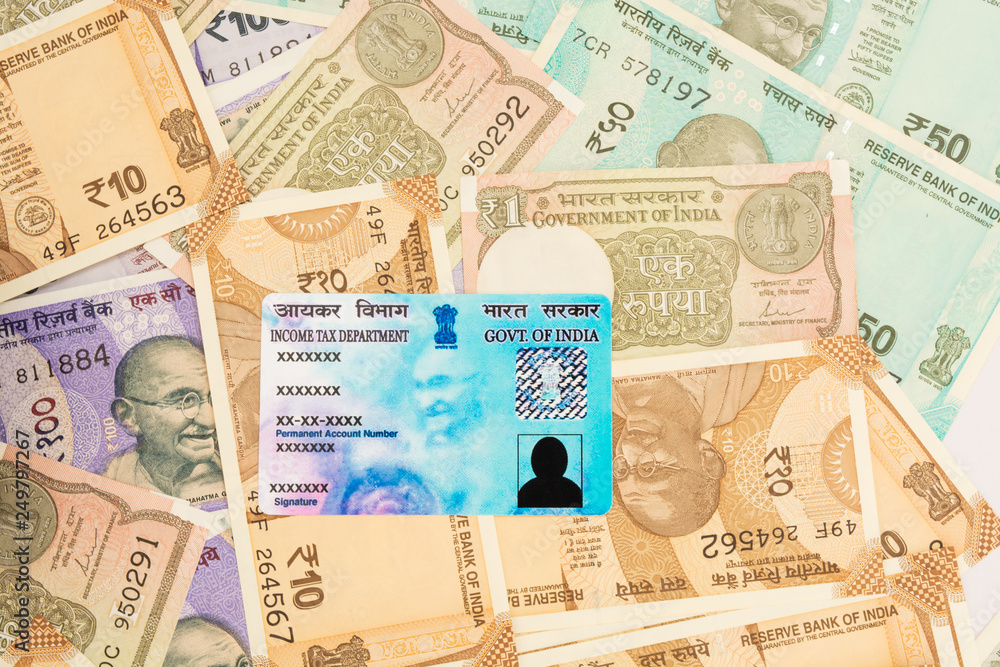 PAN card on stack of Indian new currency notes. Stock Photo | Adobe Stock