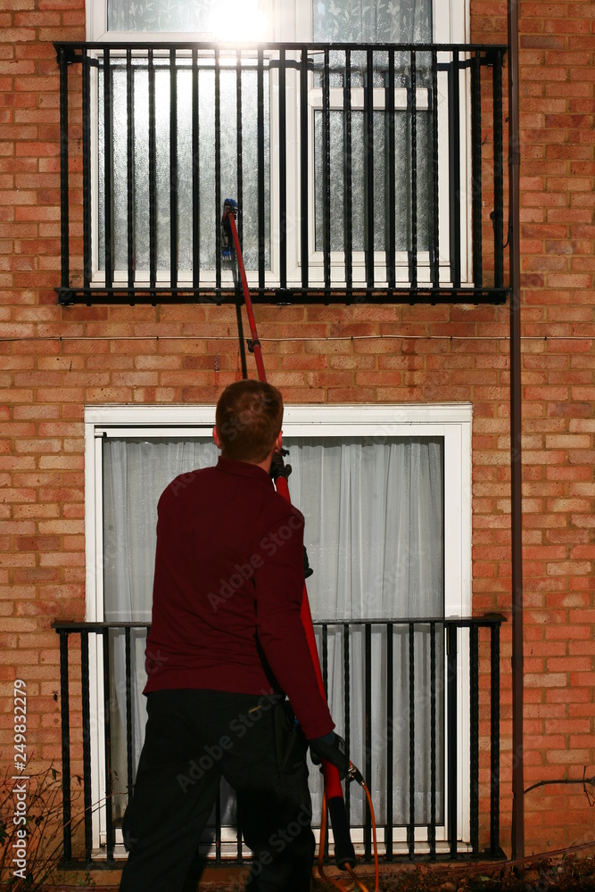 pure water window cleaning, using telescopic pole on tall building with ...