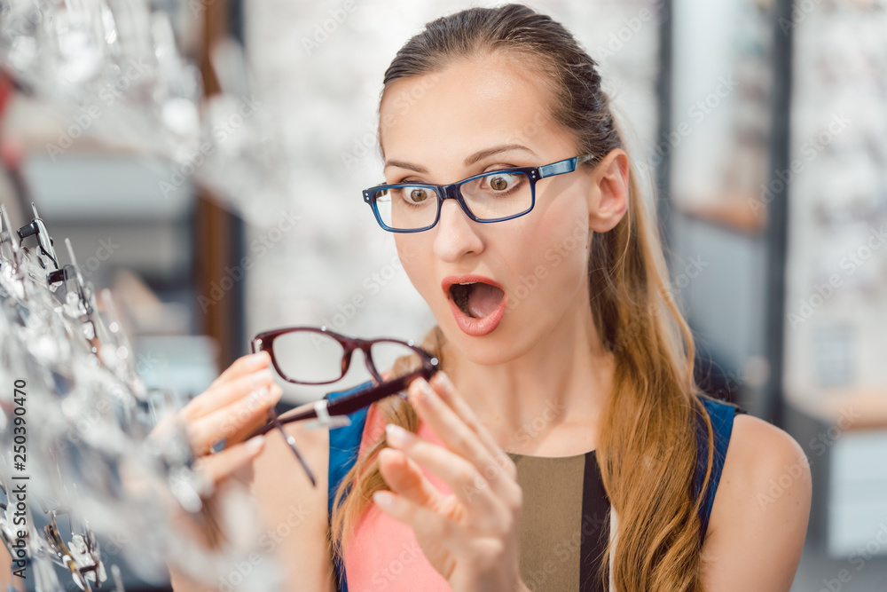 Woman loving the design of her new glasses almost too much Stock Photo ...