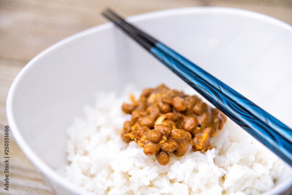 Blue chopsticks macro closeup on Asian Japanese natto fermented soy ...
