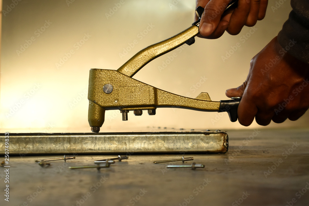 Mechanic worker use working hand tool for rivet gun in hand, work in ...