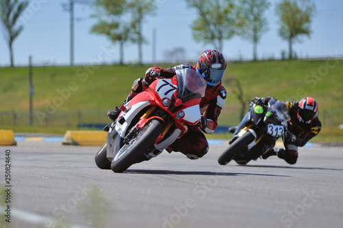 Motorcycle practice leaning into a fast corner on track - Buy this ...