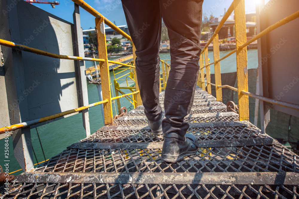 Safety shoe of worker or engineering walking in mind step on the steel ...