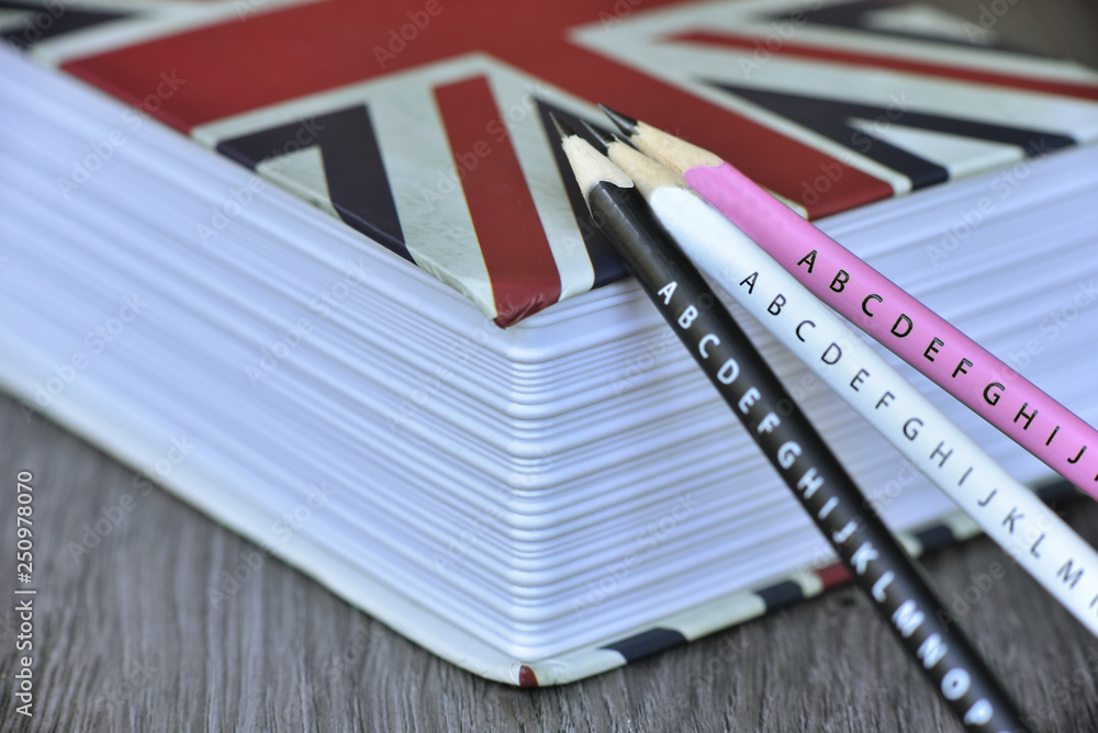 English book with english alphabet pencils. English is the language of ...