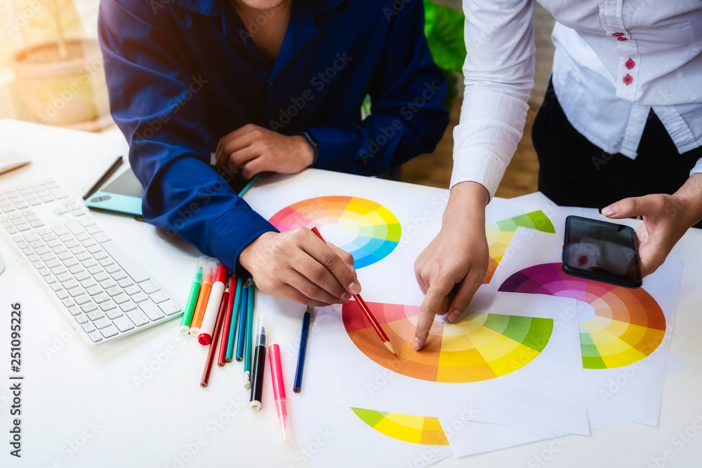 Designer graphic designer using color swatch sample with mobile phone ...