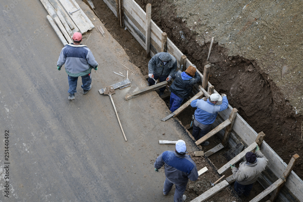 Manual workers build the foundation of the bridge on the road Stock ...