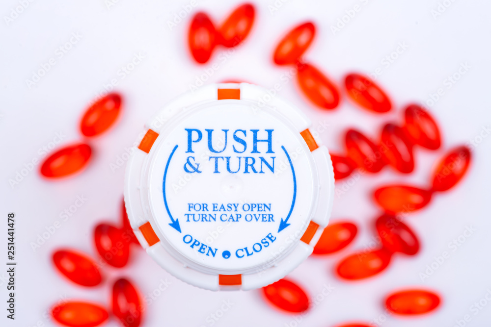 Docusate sodium red capsules and plastic container with Child-Resistant ...