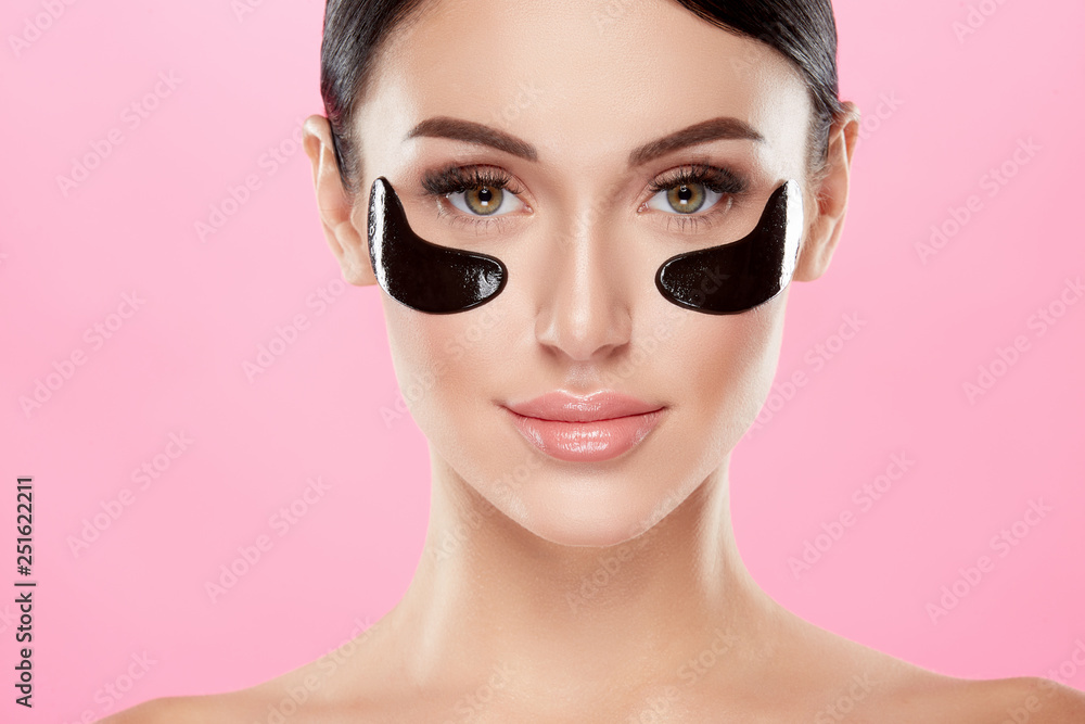 Cute girl with nude make up and naked shoulders at studio background ...