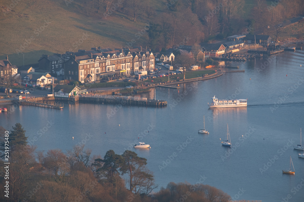 Lake cruiser arriving in at Lakehead, Ambleside at sunset. Lake ...